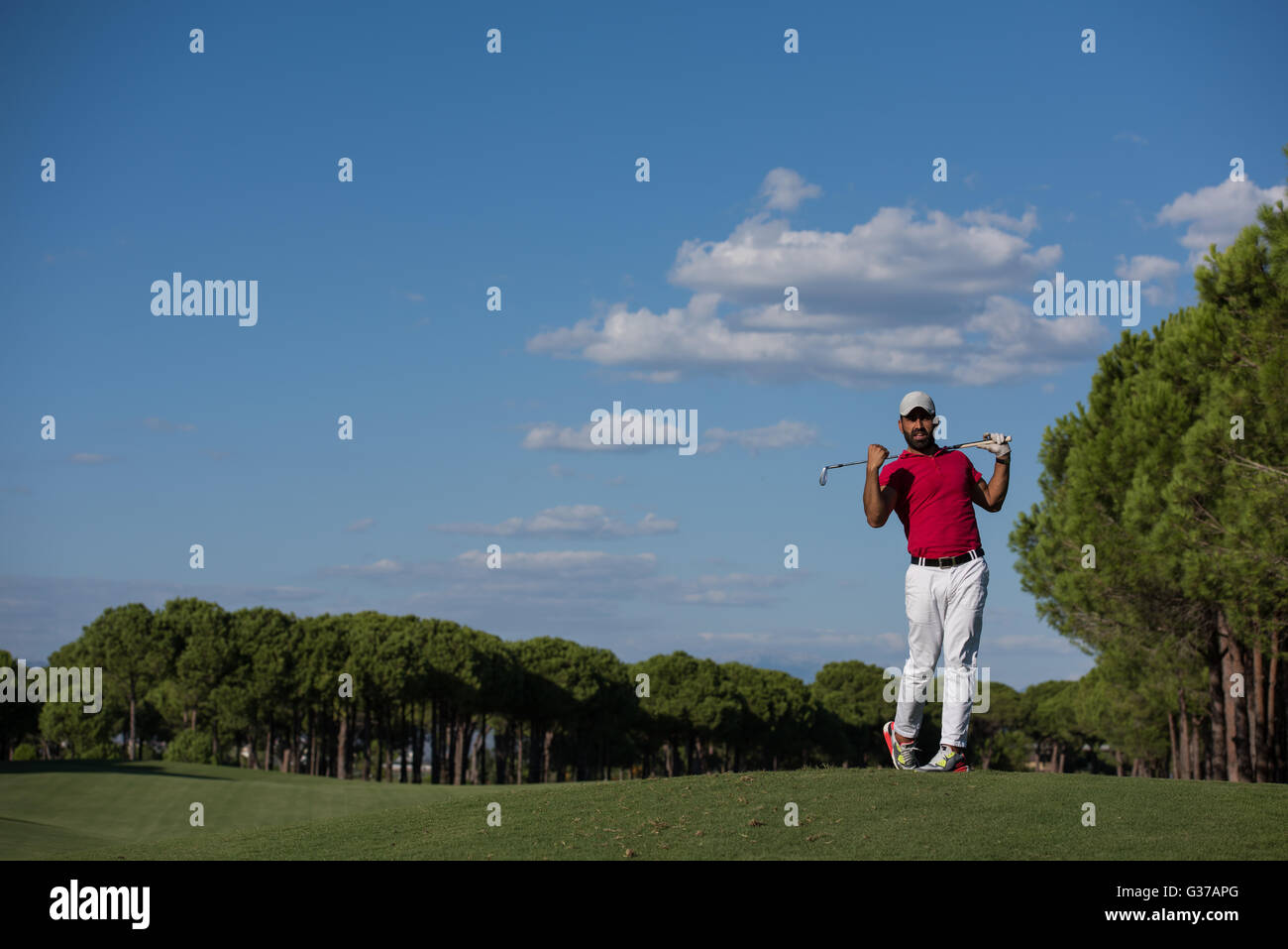 golf player hitting shot with driver on course at beautiful sunny day ...