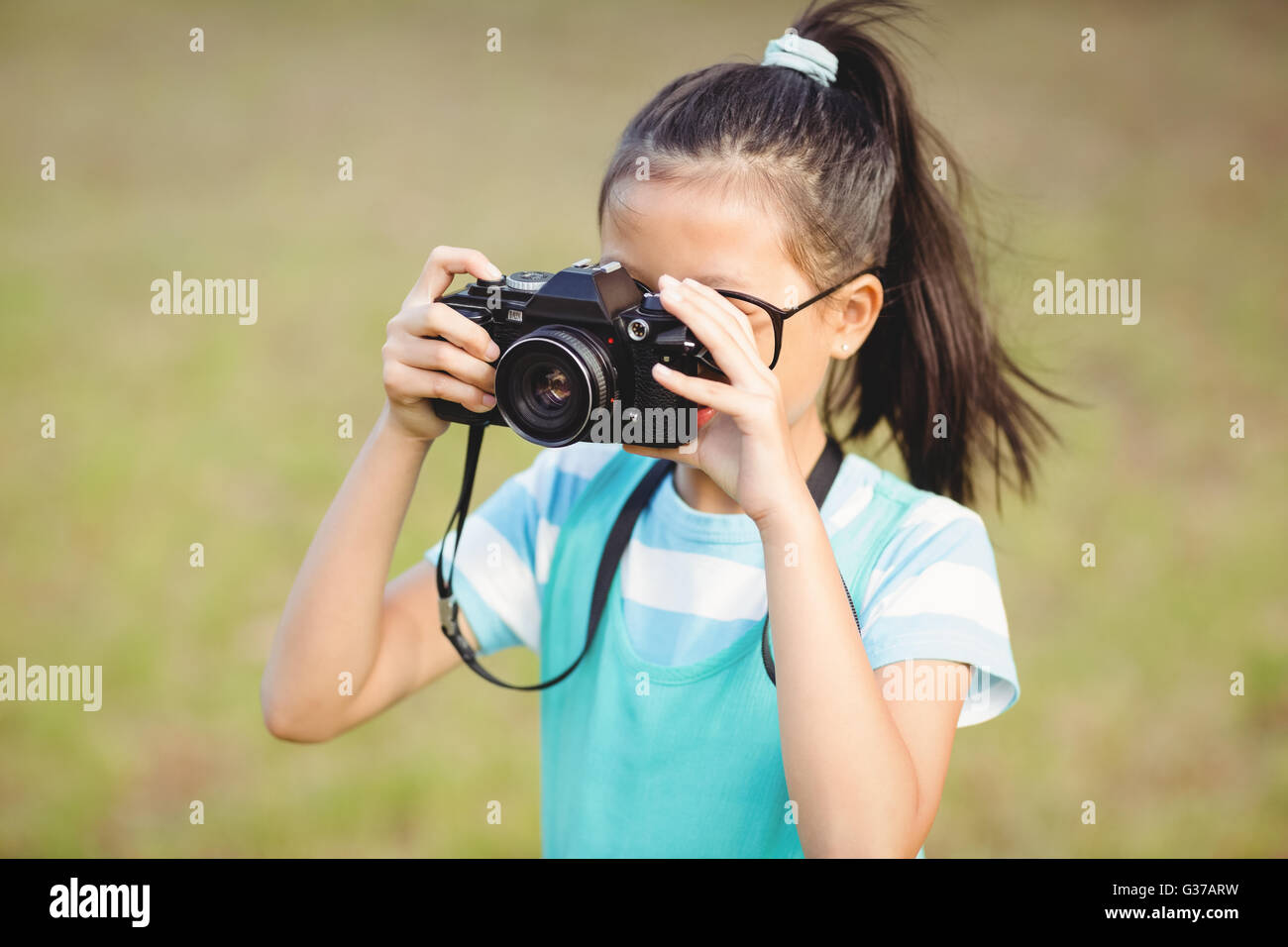 Young girl clicking a photograph from camera Stock Photo - Alamy