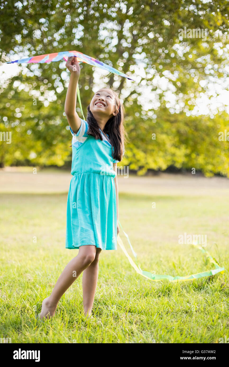 Girl holding a kite in park Stock Photo - Alamy