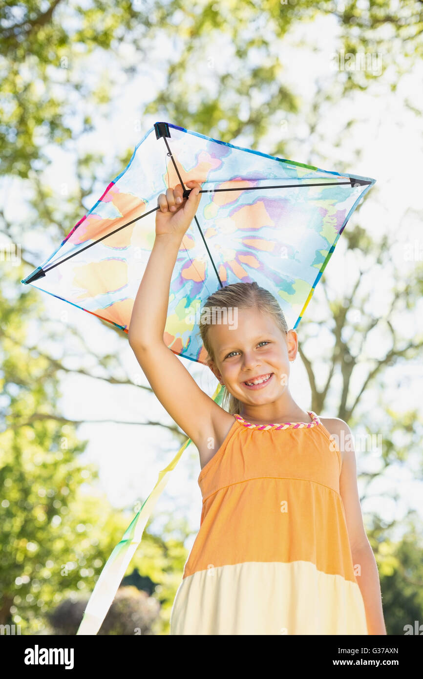 Portrait of smiling girl holding kite in park Stock Photo - Alamy