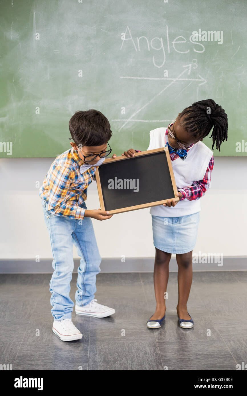 School kids looking at slate in classroom Stock Photo - Alamy