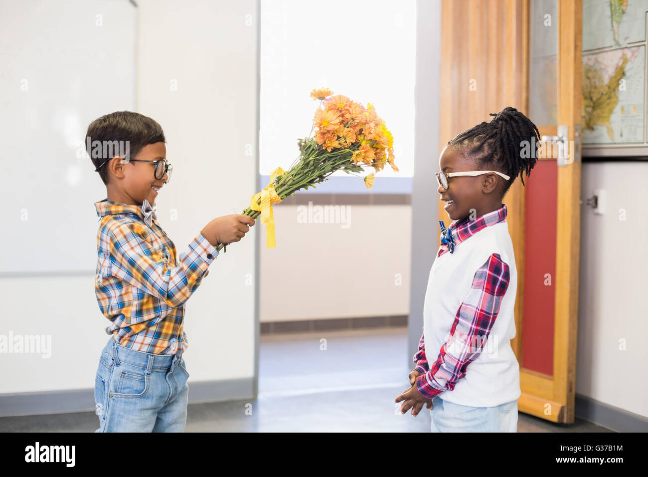 Schoolboy giving a bunch of flowers to a girl Stock Photo - Alamy