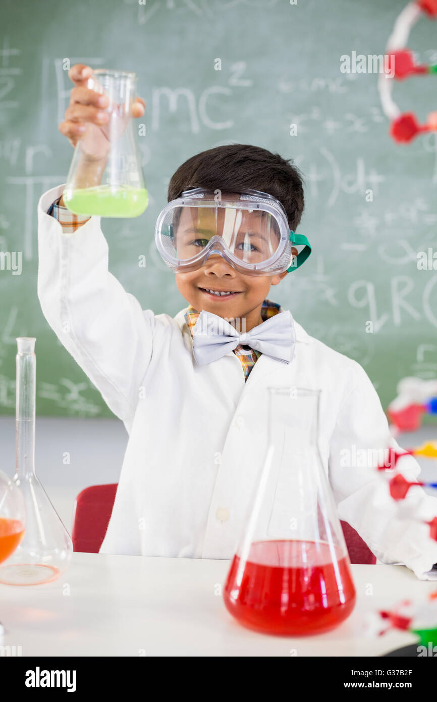 Portrait of schoolboy doing a chemical experiment in laboratory Stock ...