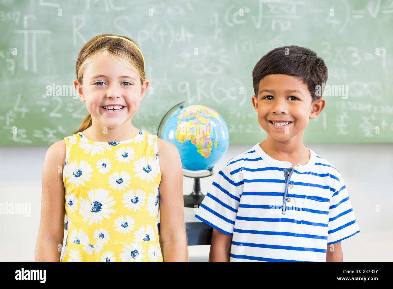 Portrait of happy school kids standing in classroom Stock Photo - Alamy