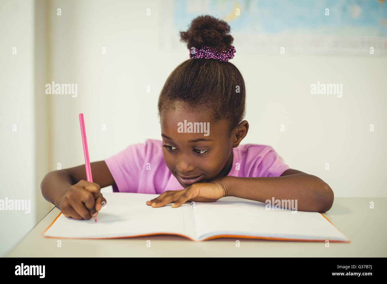 School girl doing homework in classroom Stock Photo - Alamy