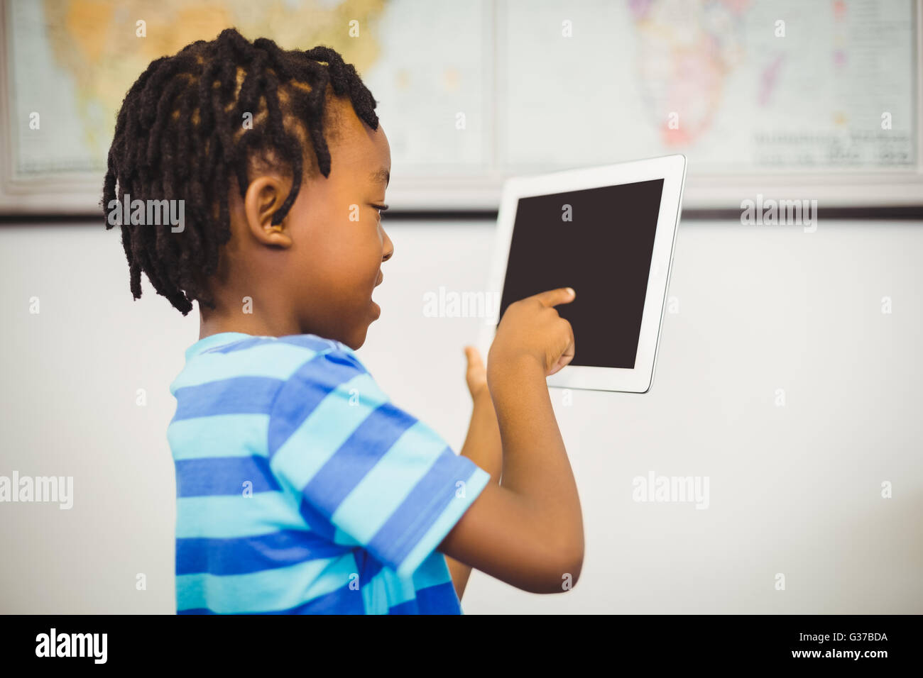 School boy using a digital tablet in classroom Stock Photo - Alamy