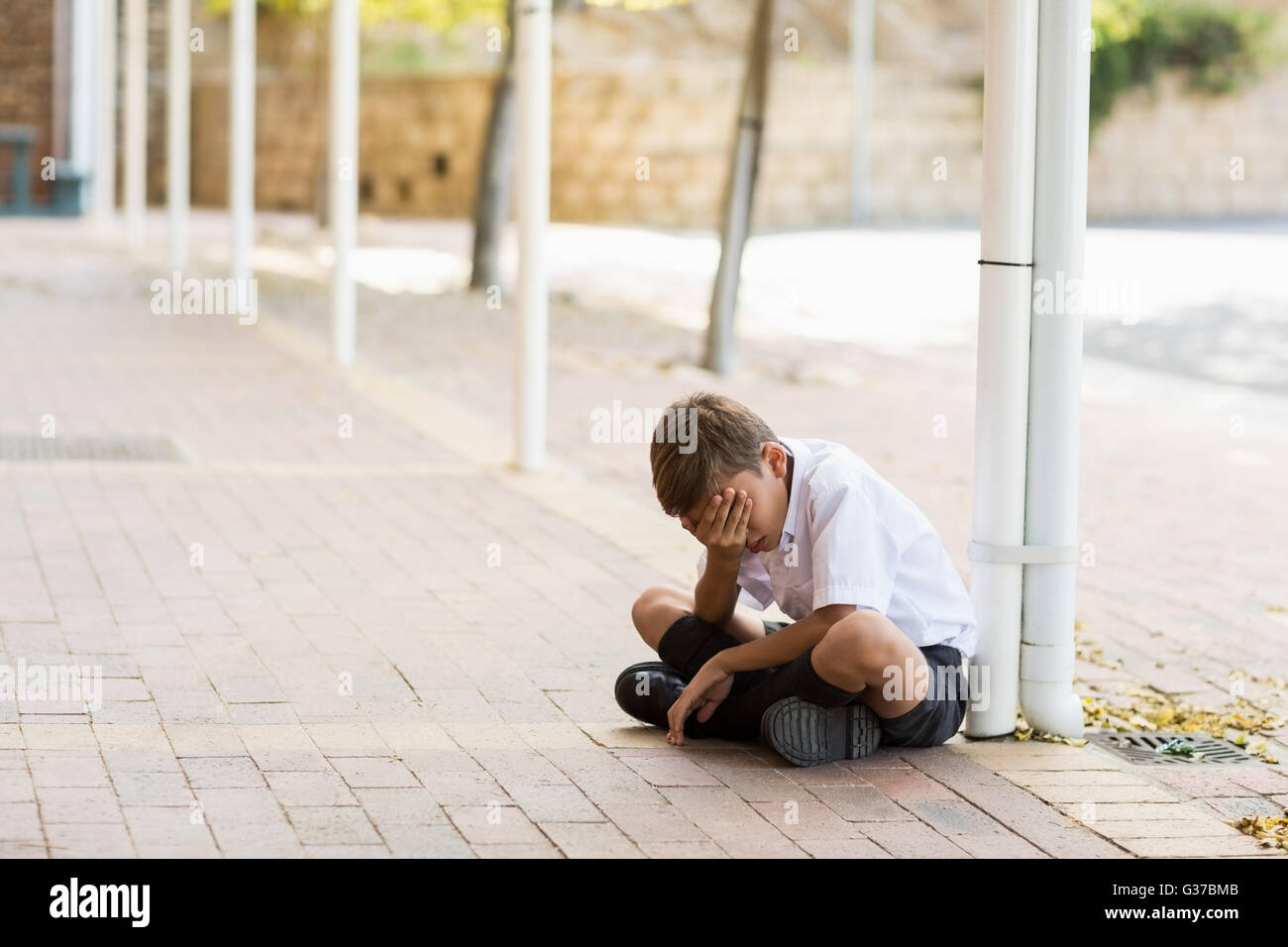 Child sitting school hallway sad hi-res stock photography and images ...