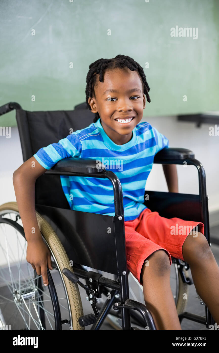 Portrait of cute boy sitting on wheelchair Stock Photo - Alamy