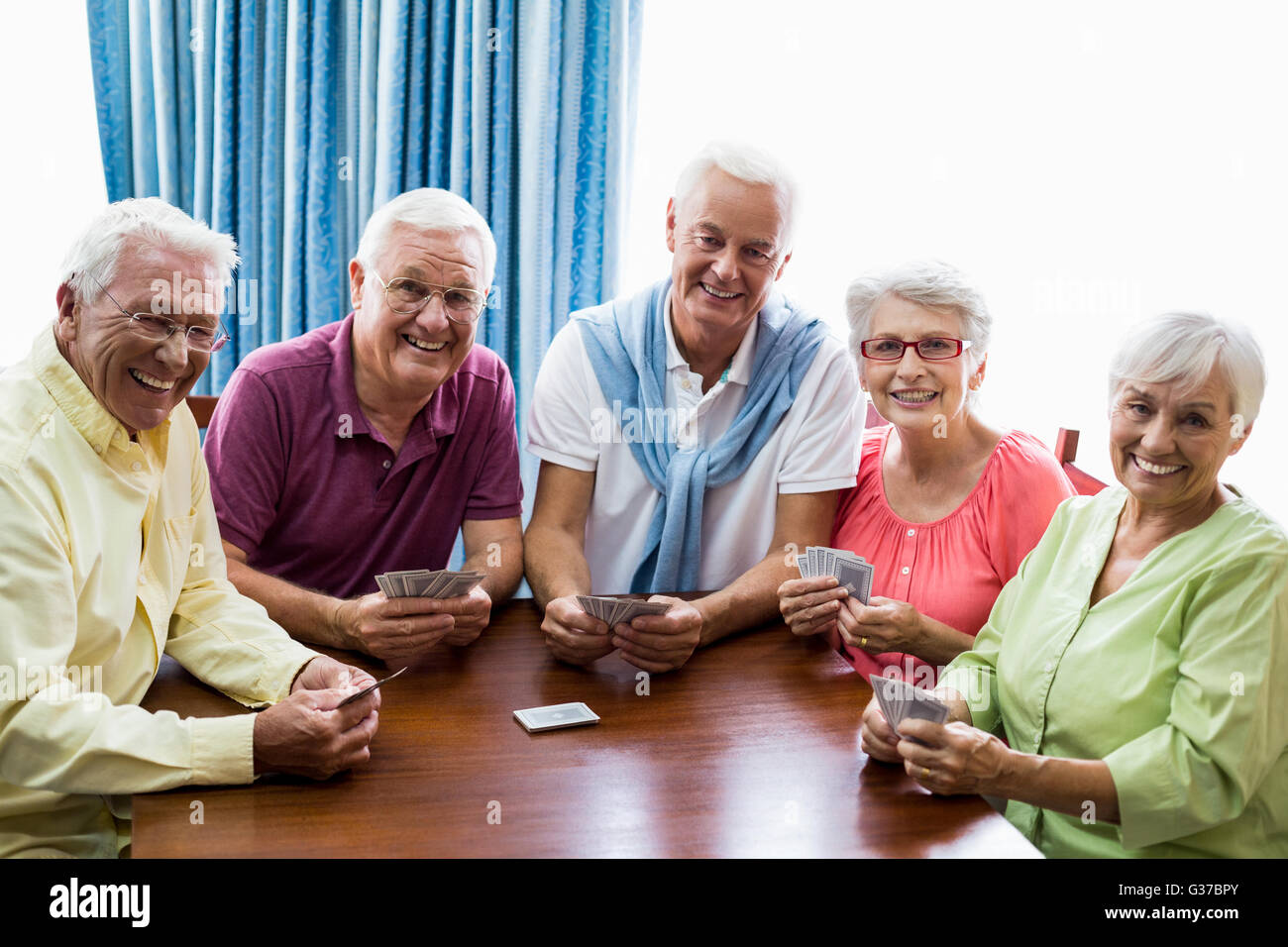 Seniors playing cards together Stock Photo - Alamy