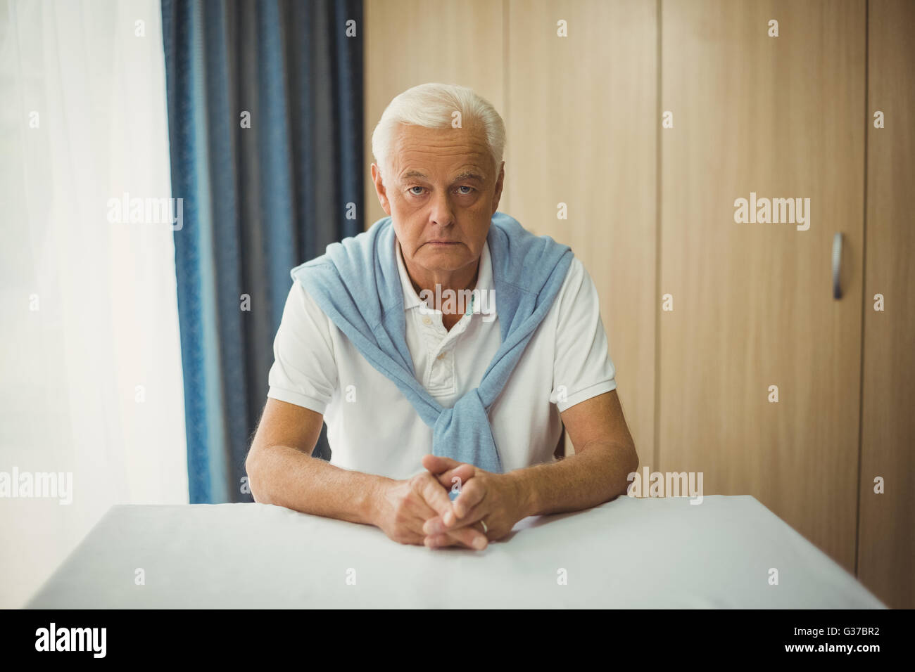 Man at table unhappy hi-res stock photography and images - Alamy