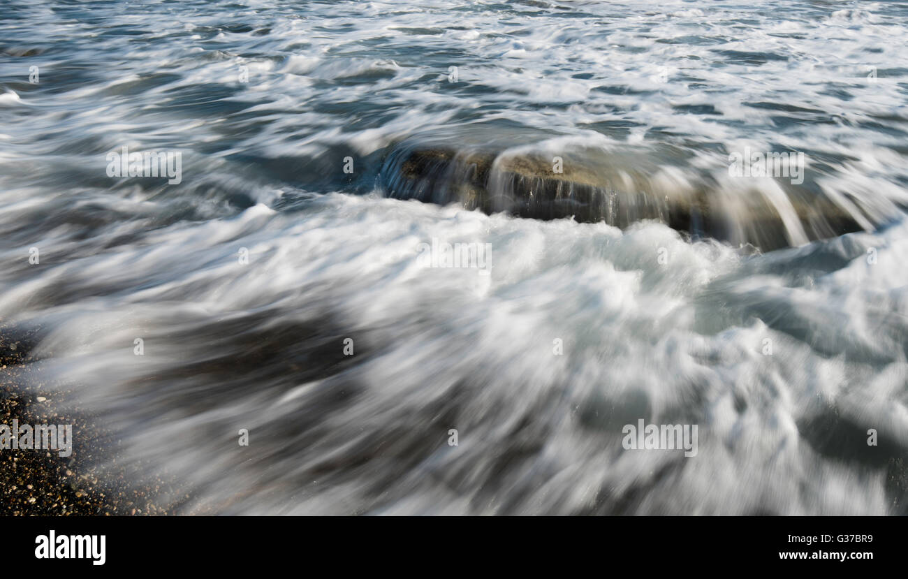 Sea waves flowing above a sea rock creating a beautiful nature water ...