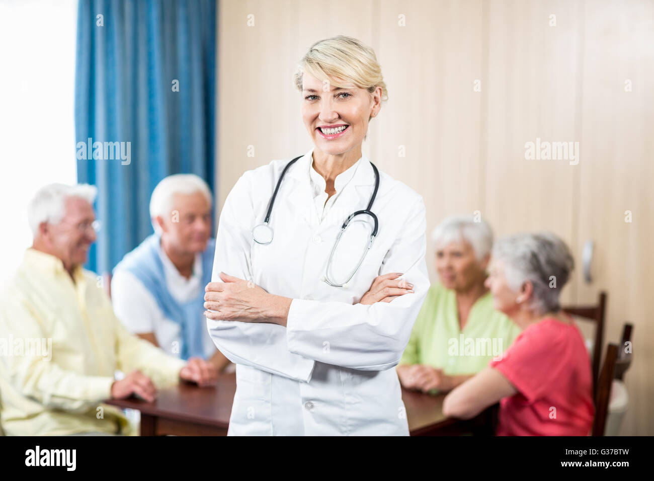 Nurse standing with arms crossed Stock Photo - Alamy