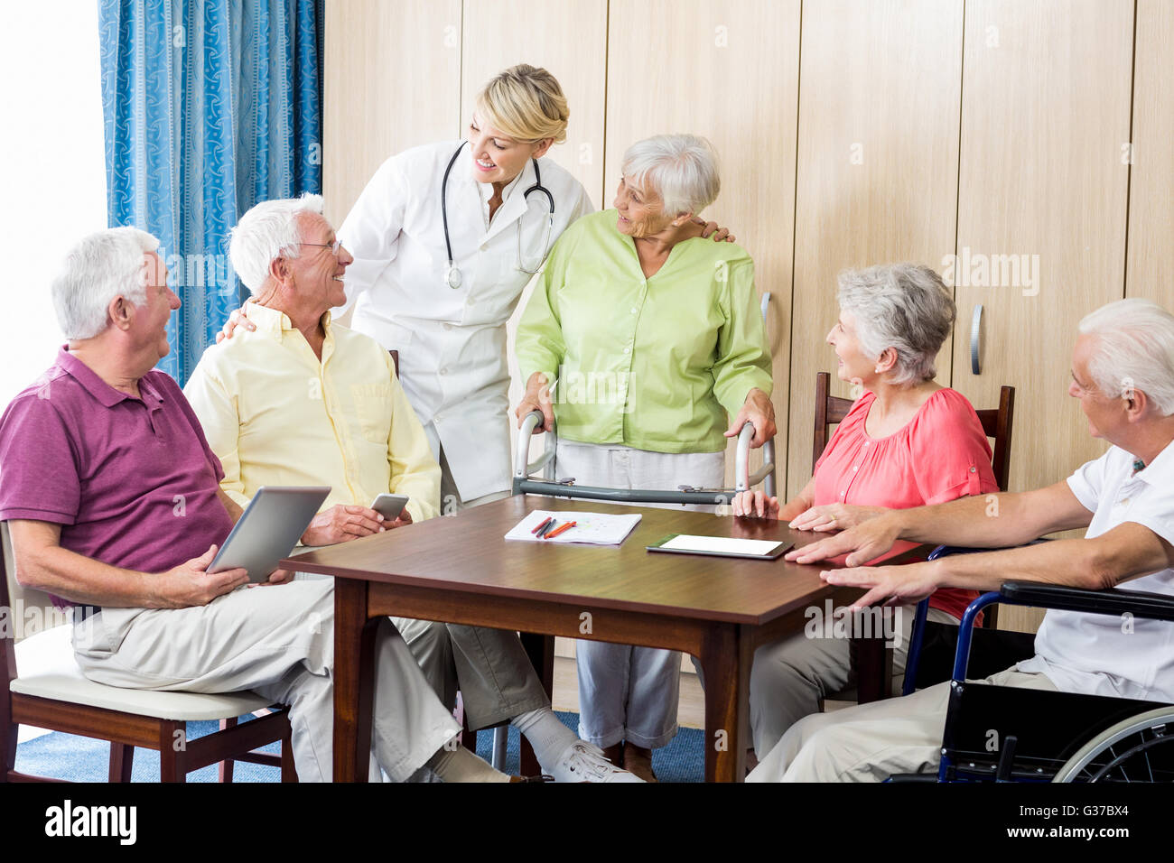 Seniors with wheelchair and walking aid Stock Photo - Alamy