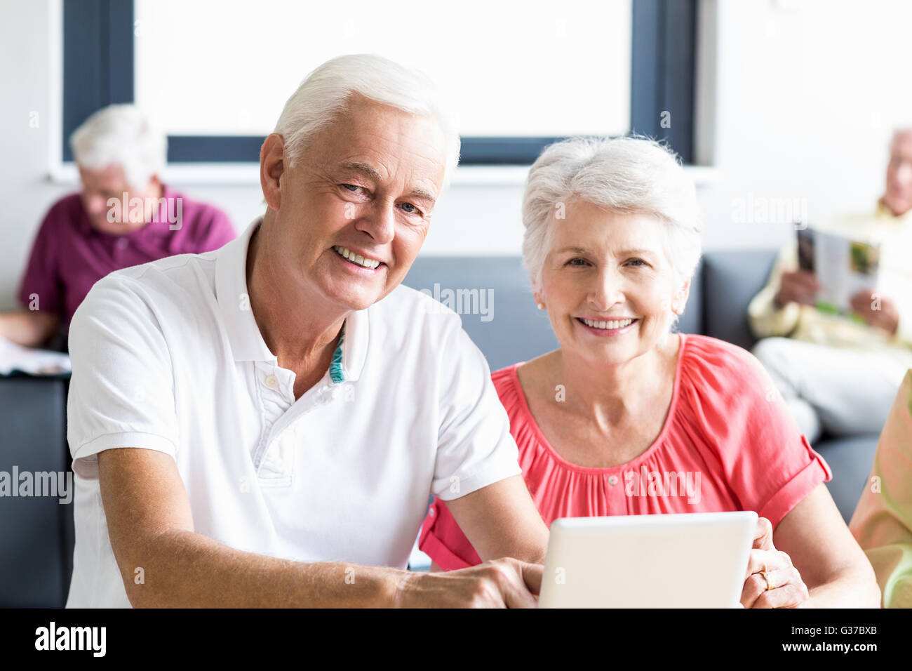 Seniors using a tablet Stock Photo - Alamy