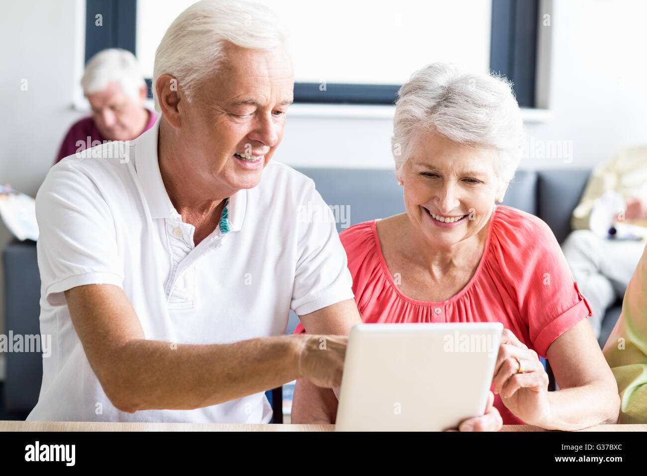 Seniors using a tablet Stock Photo - Alamy