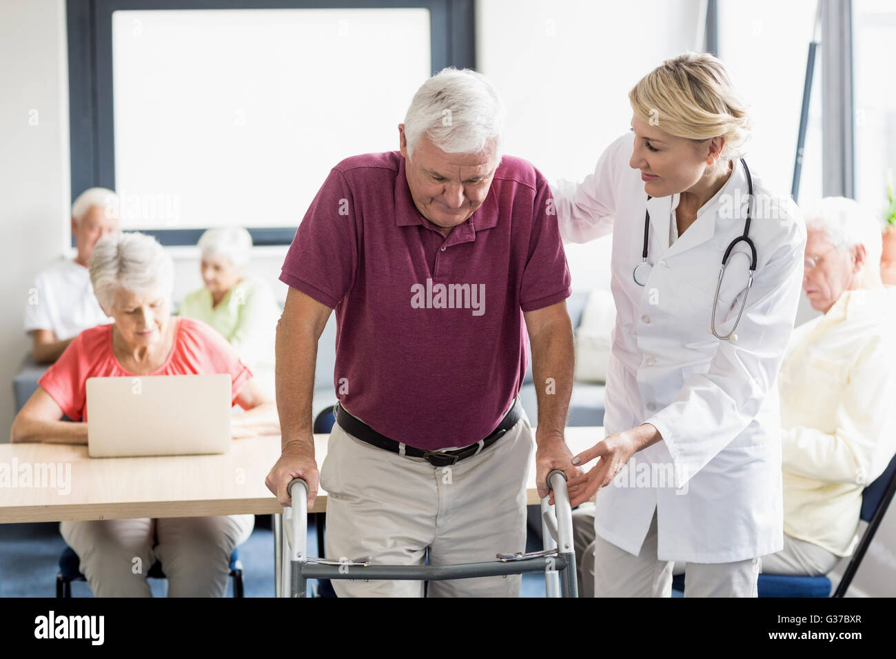 Nurse helping senior with walking aid Stock Photo - Alamy