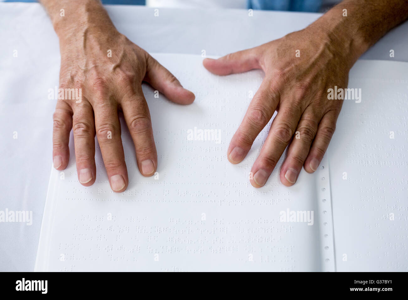 Senior using braille to read Stock Photo - Alamy