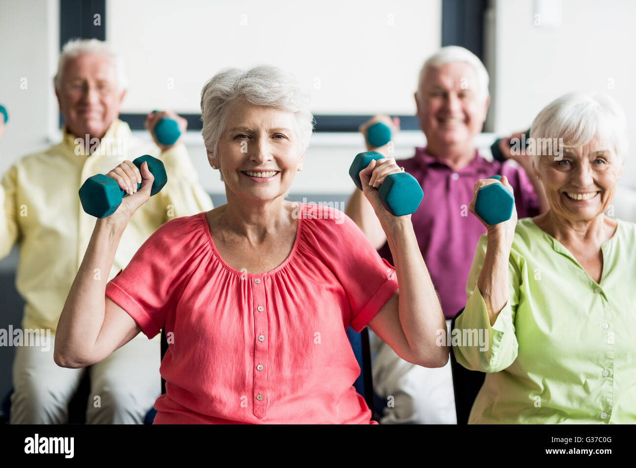 Seniors using weights Stock Photo - Alamy