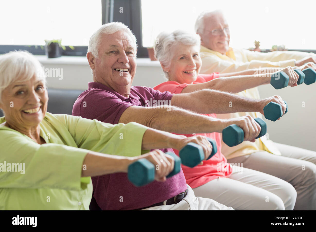 Seniors using weights Stock Photo - Alamy