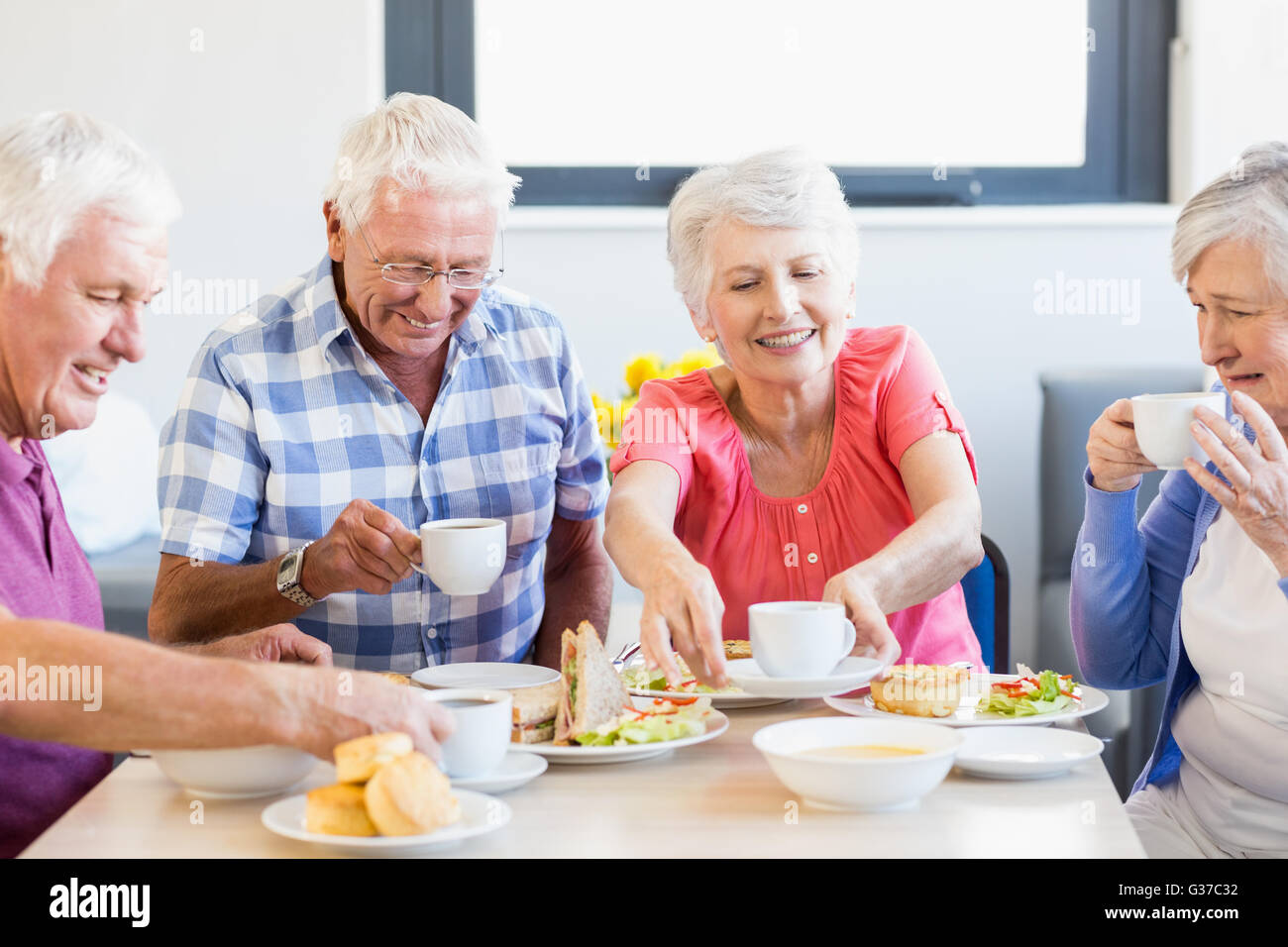 Seniors having lunch together Stock Photo - Alamy