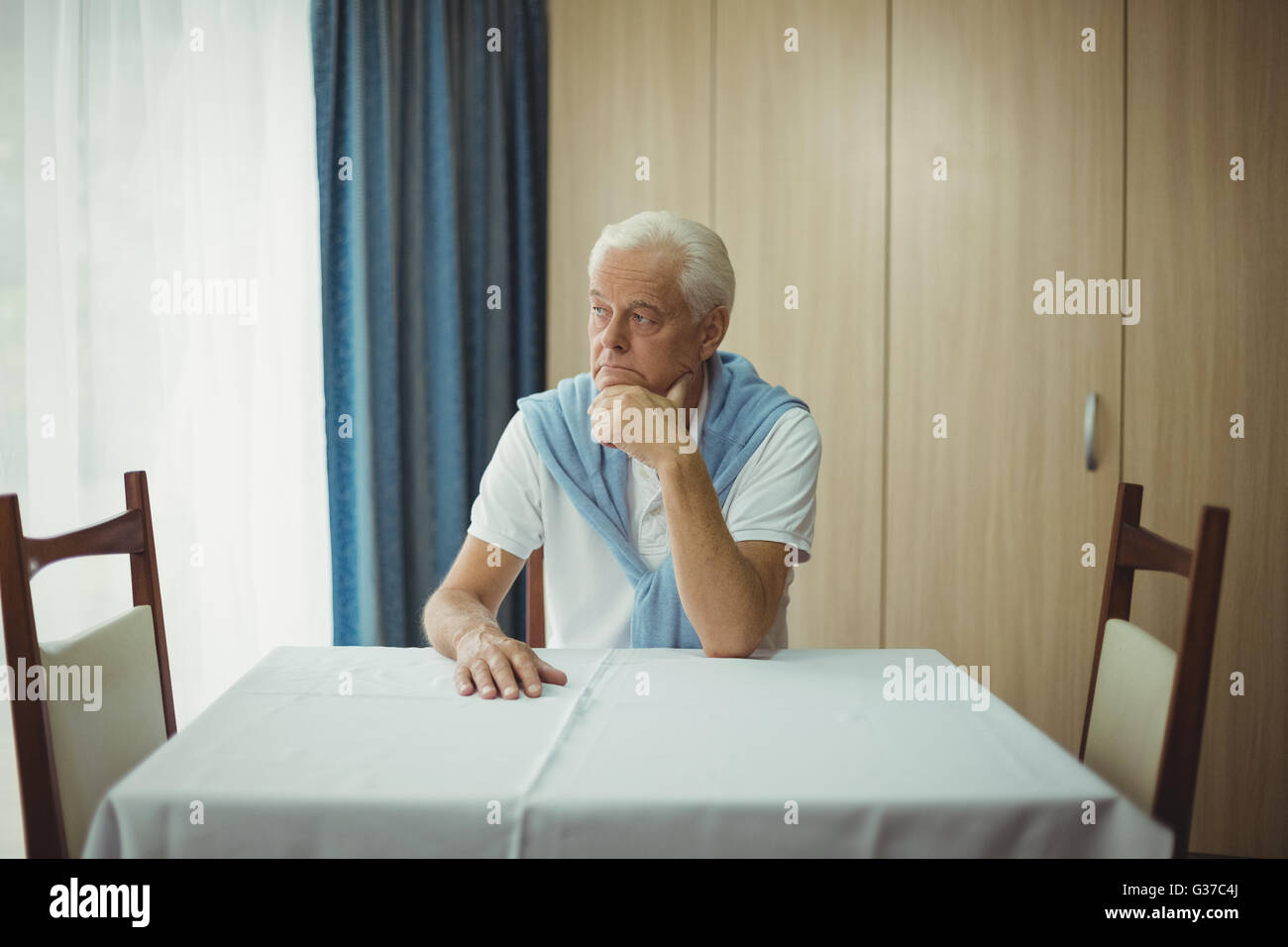 Man at table unhappy hi-res stock photography and images - Alamy