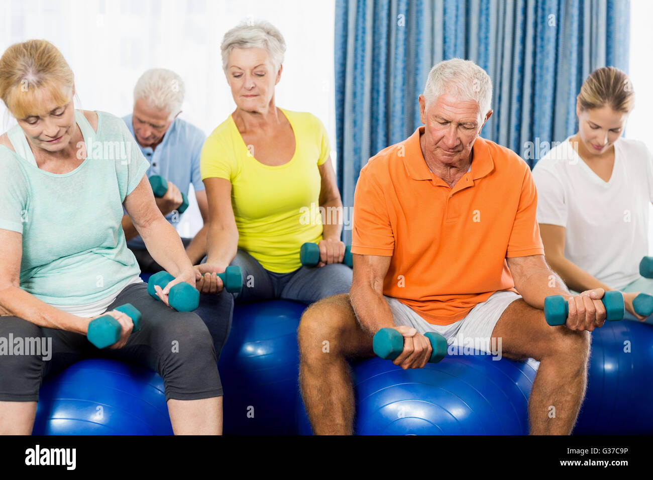 Seniors using exercise ball and weights Stock Photo - Alamy