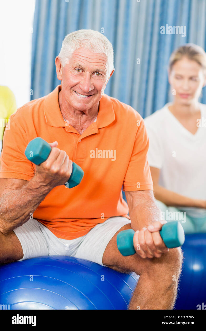 Seniors using exercise ball and weights Stock Photo - Alamy