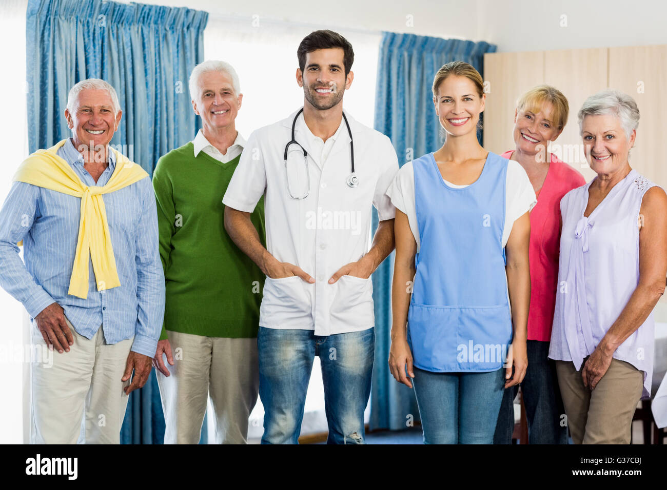 Nurse and seniors standing together Stock Photo - Alamy