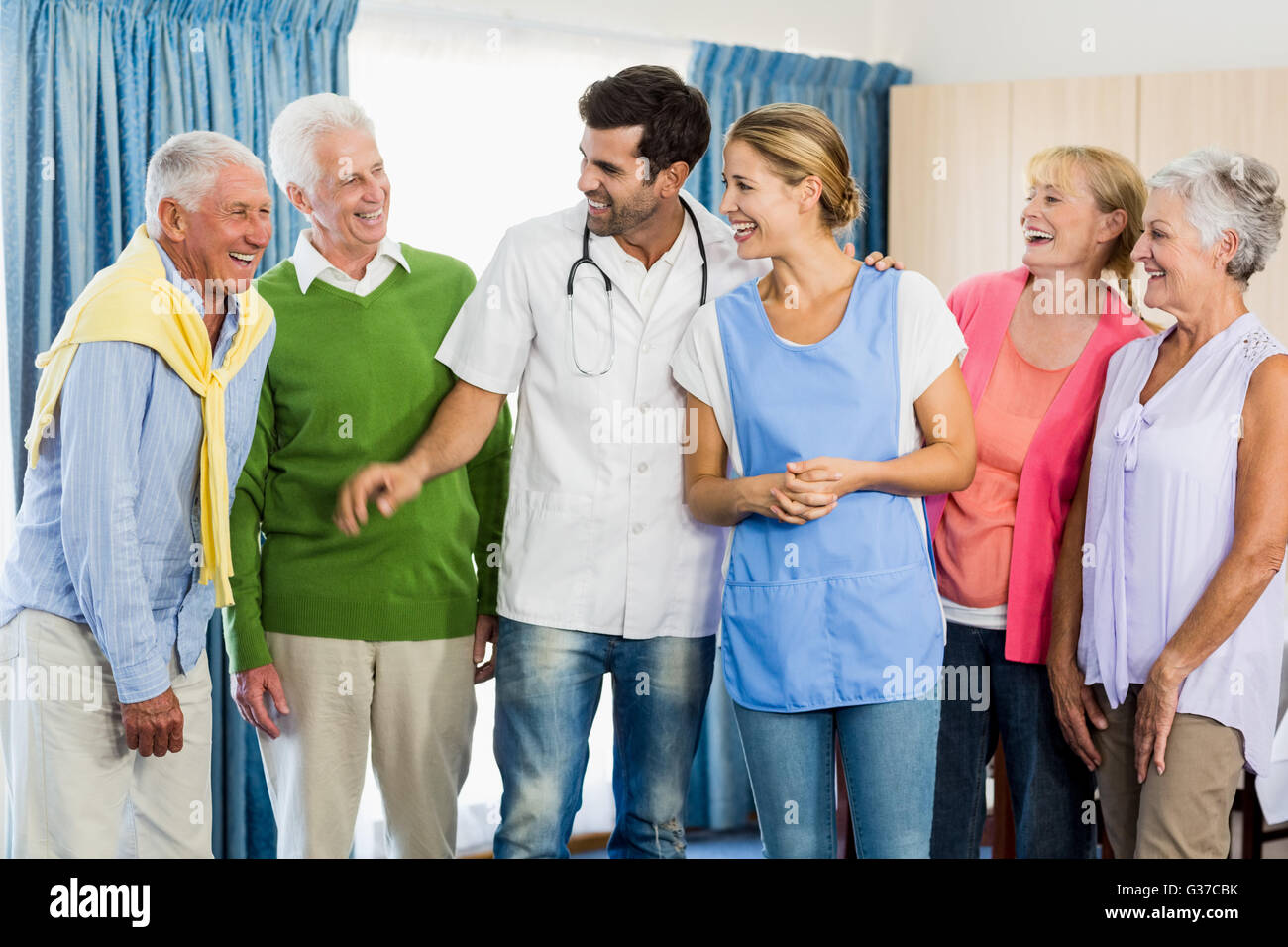 Nurse and seniors standing together Stock Photo - Alamy