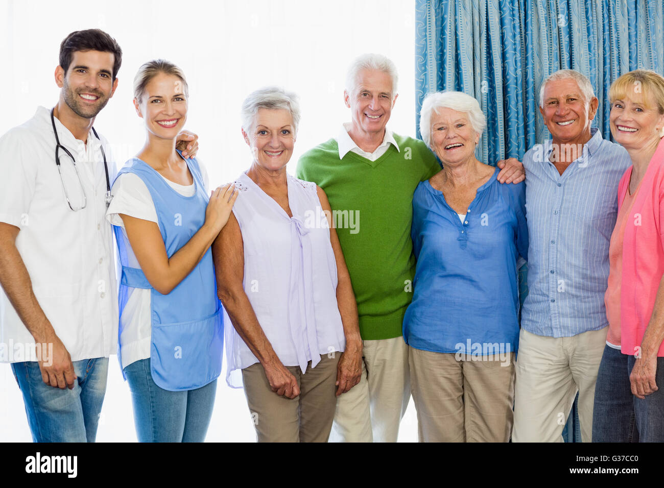 Nurse and seniors standing together Stock Photo - Alamy