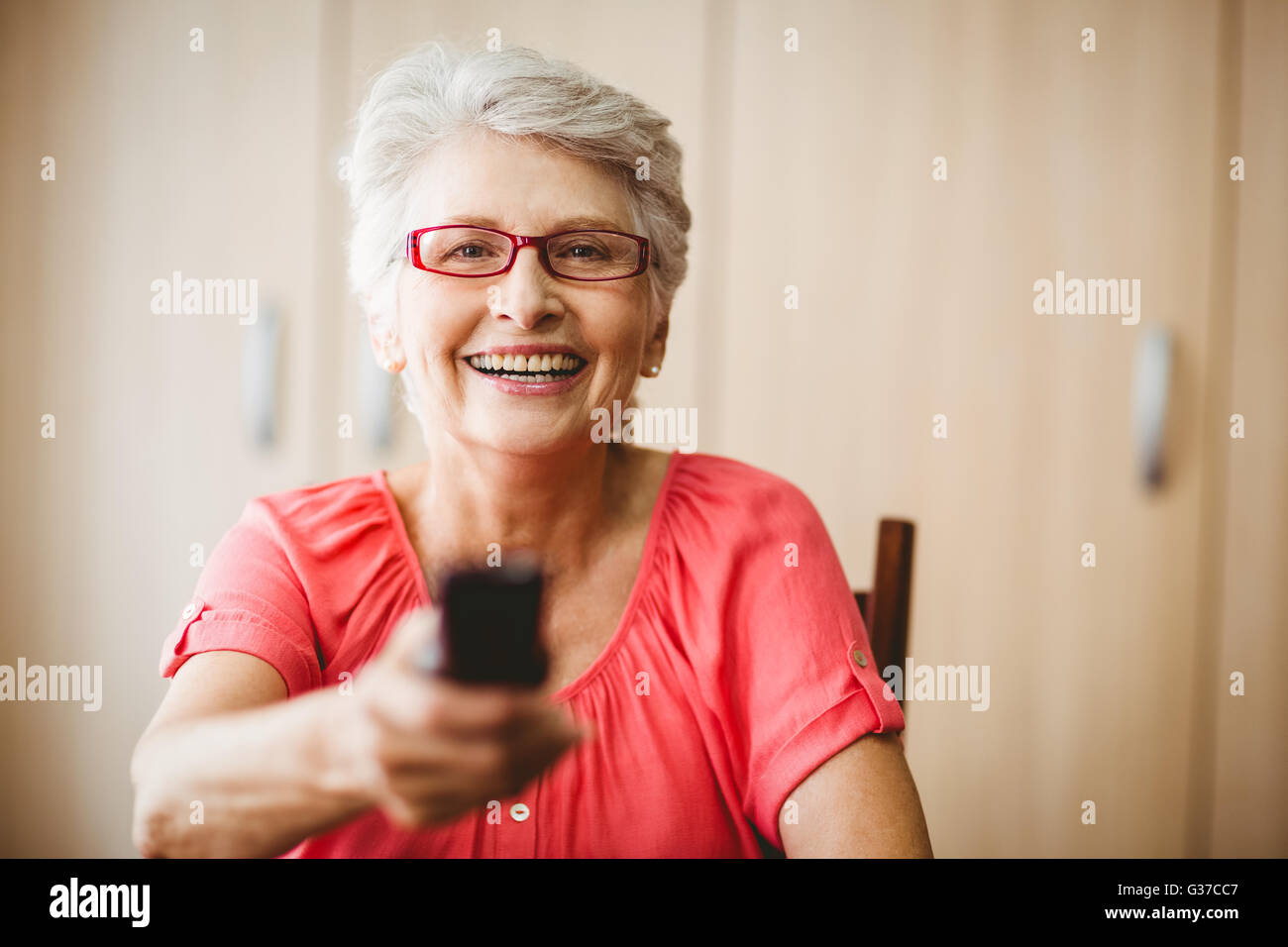 Holding a remote control hi-res stock photography and images - Alamy
