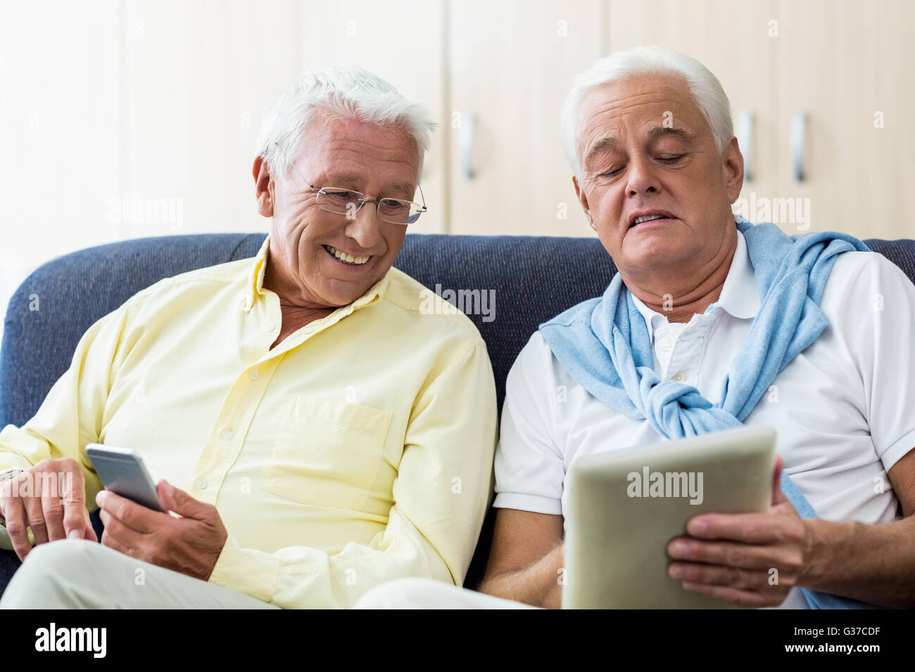 Senior men using technology Stock Photo - Alamy