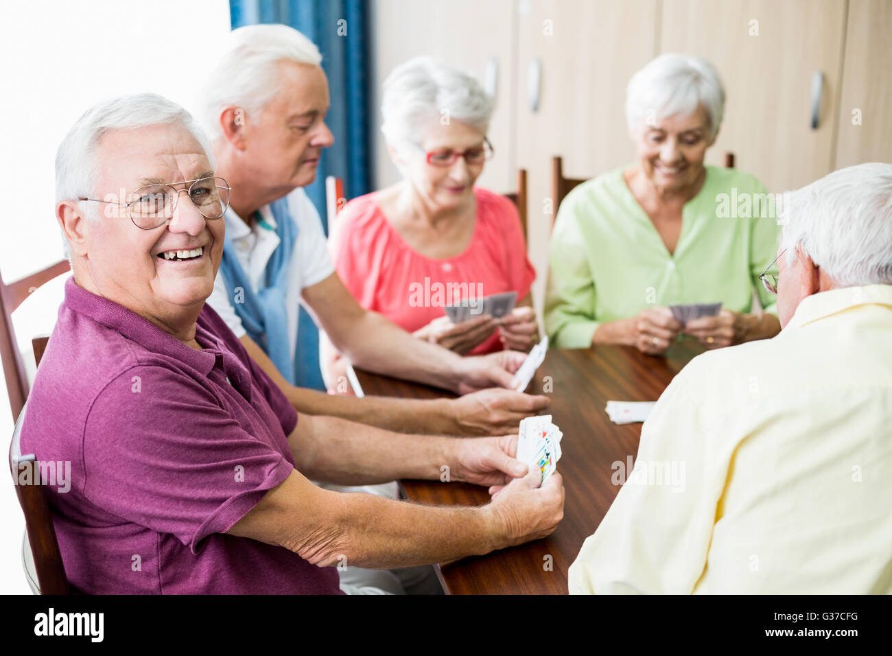 Seniors playing cards together Stock Photo - Alamy