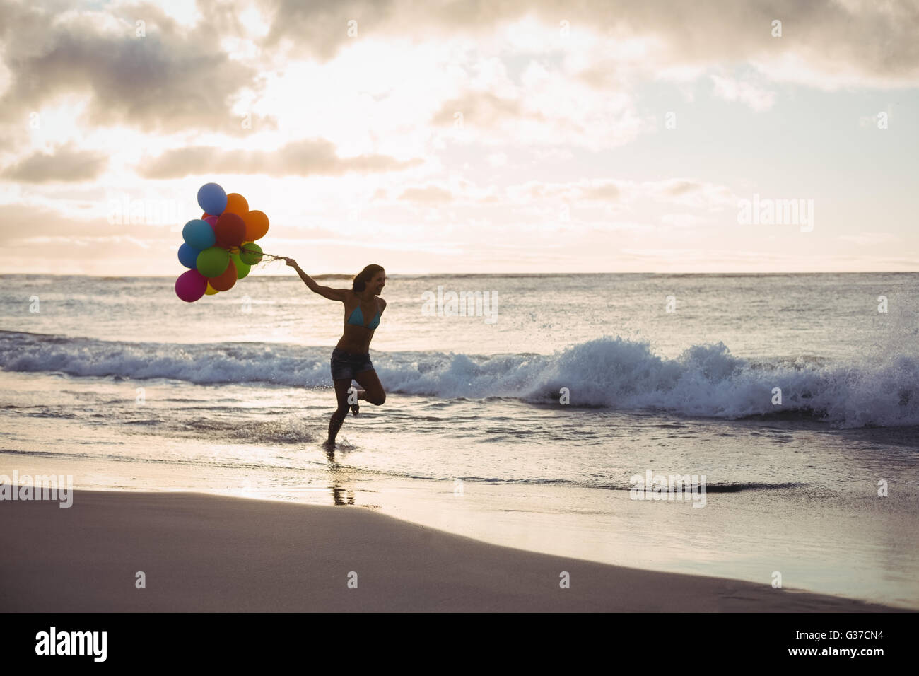 Woman running with the balloon Stock Photo - Alamy