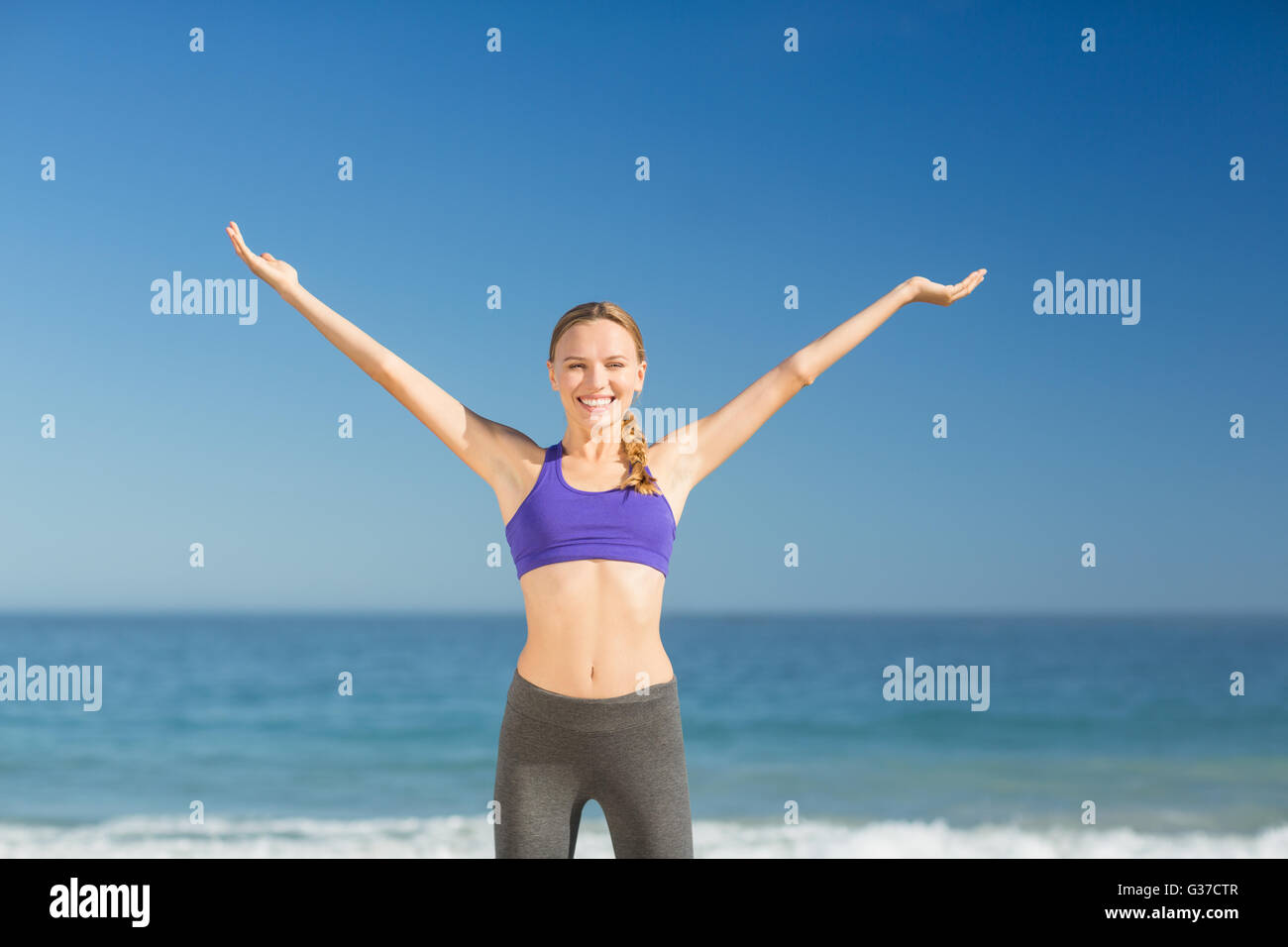 Beautiful young woman smiling while exercising Stock Photo - Alamy