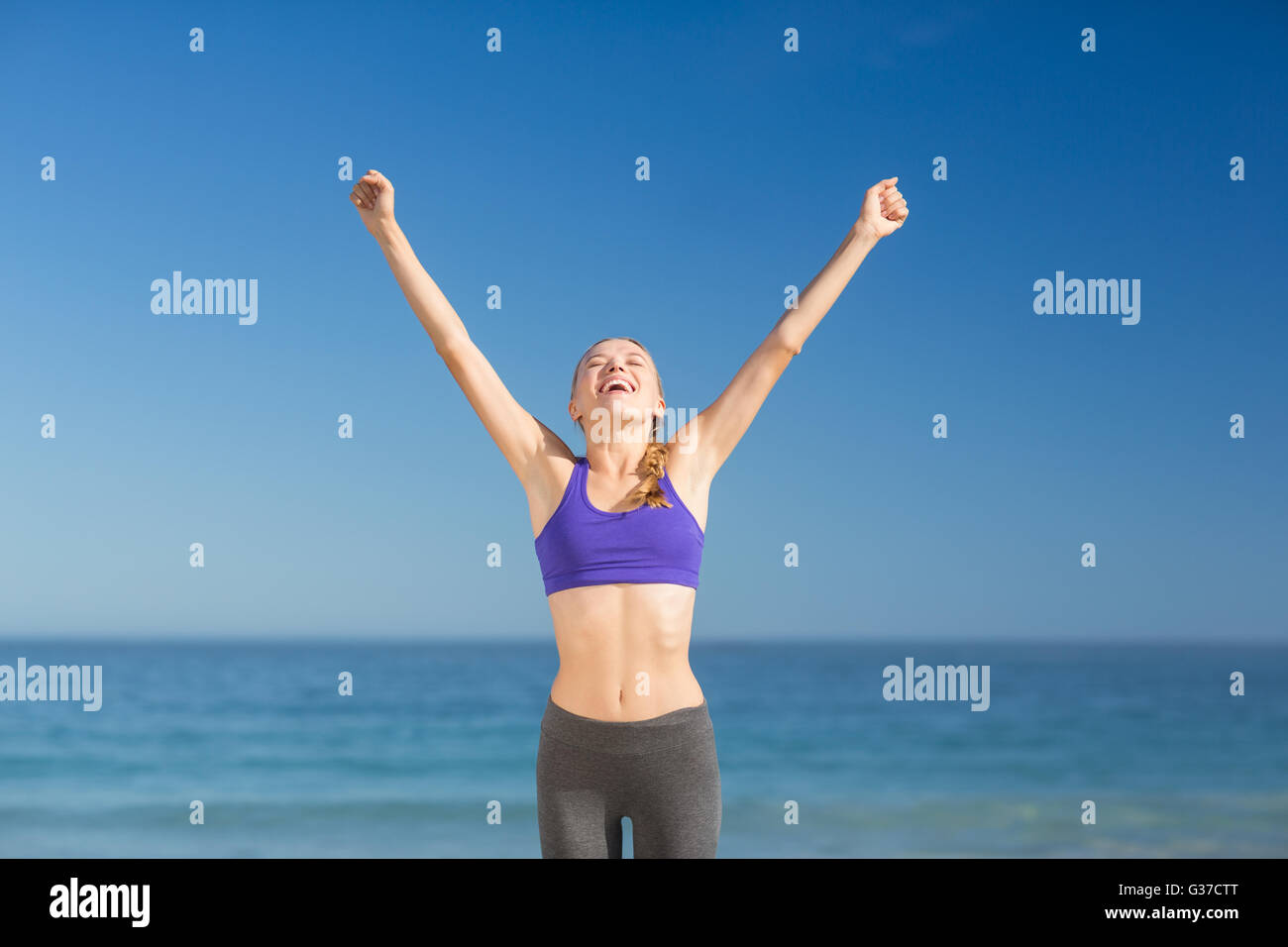 Beautiful young woman smiling while exercising Stock Photo - Alamy