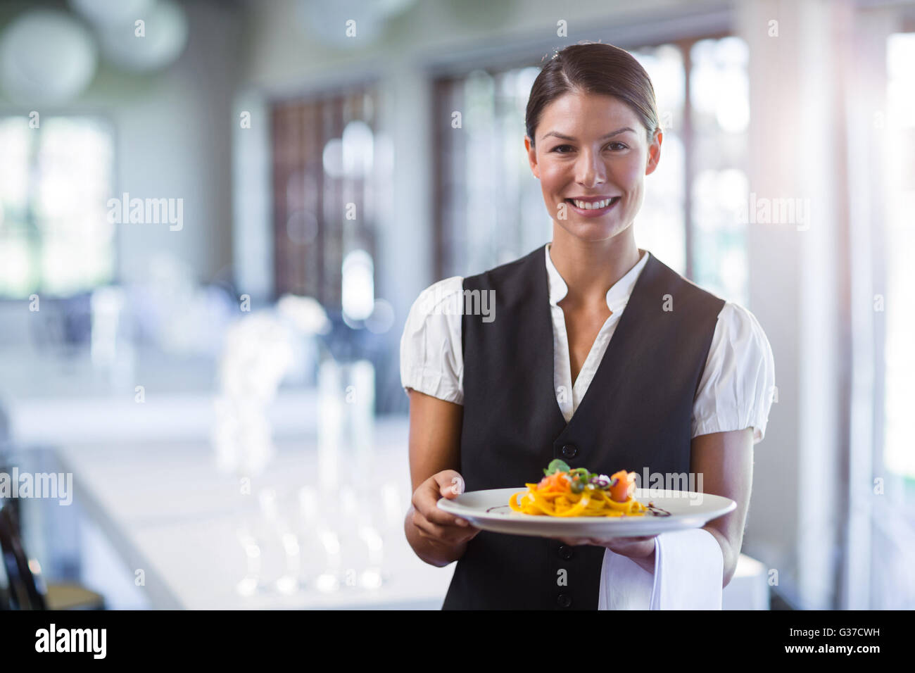 Smiling waitress serving meal hi-res stock photography and images - Alamy