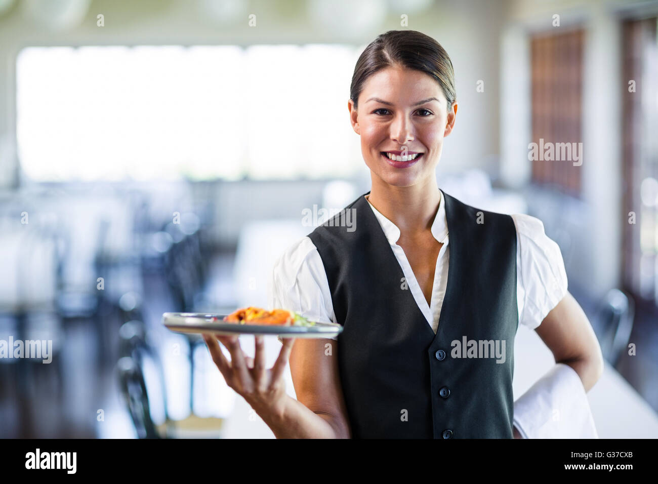 Smiling waitress serving meal hi-res stock photography and images - Alamy