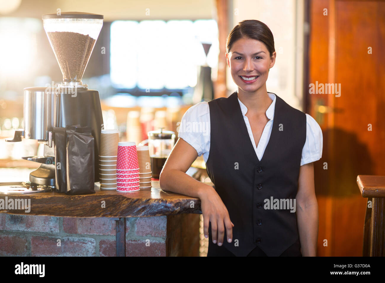 Portrait of waitress standing at counter Stock Photo - Alamy