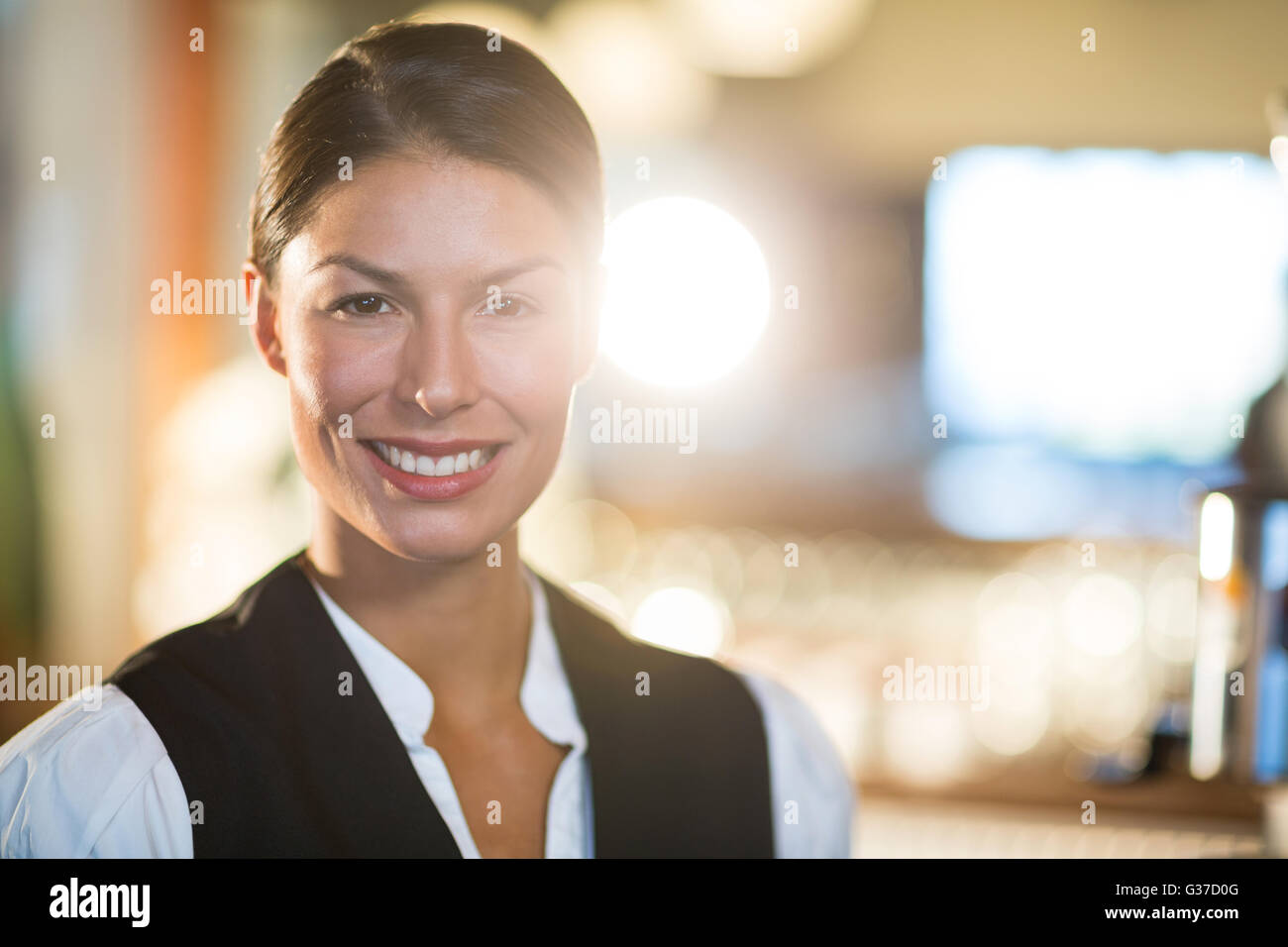 Portrait of smiling waitress Stock Photo - Alamy