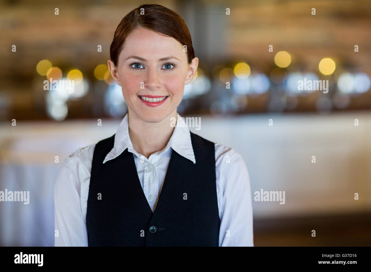 Portrait of smiling waitress Stock Photo - Alamy