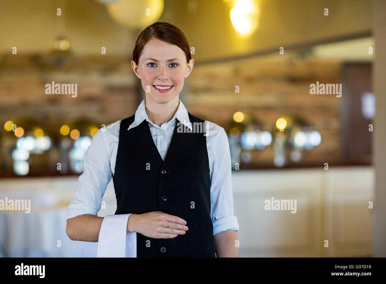 Waitress with napkin draped over her hand Stock Photo - Alamy