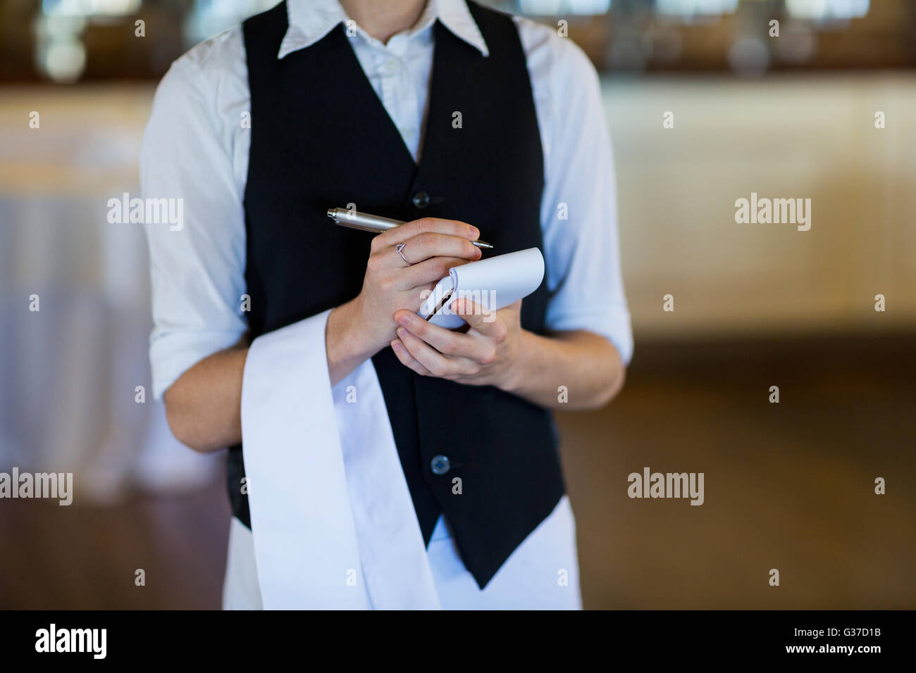 Mid section of waitress taking order Stock Photo - Alamy