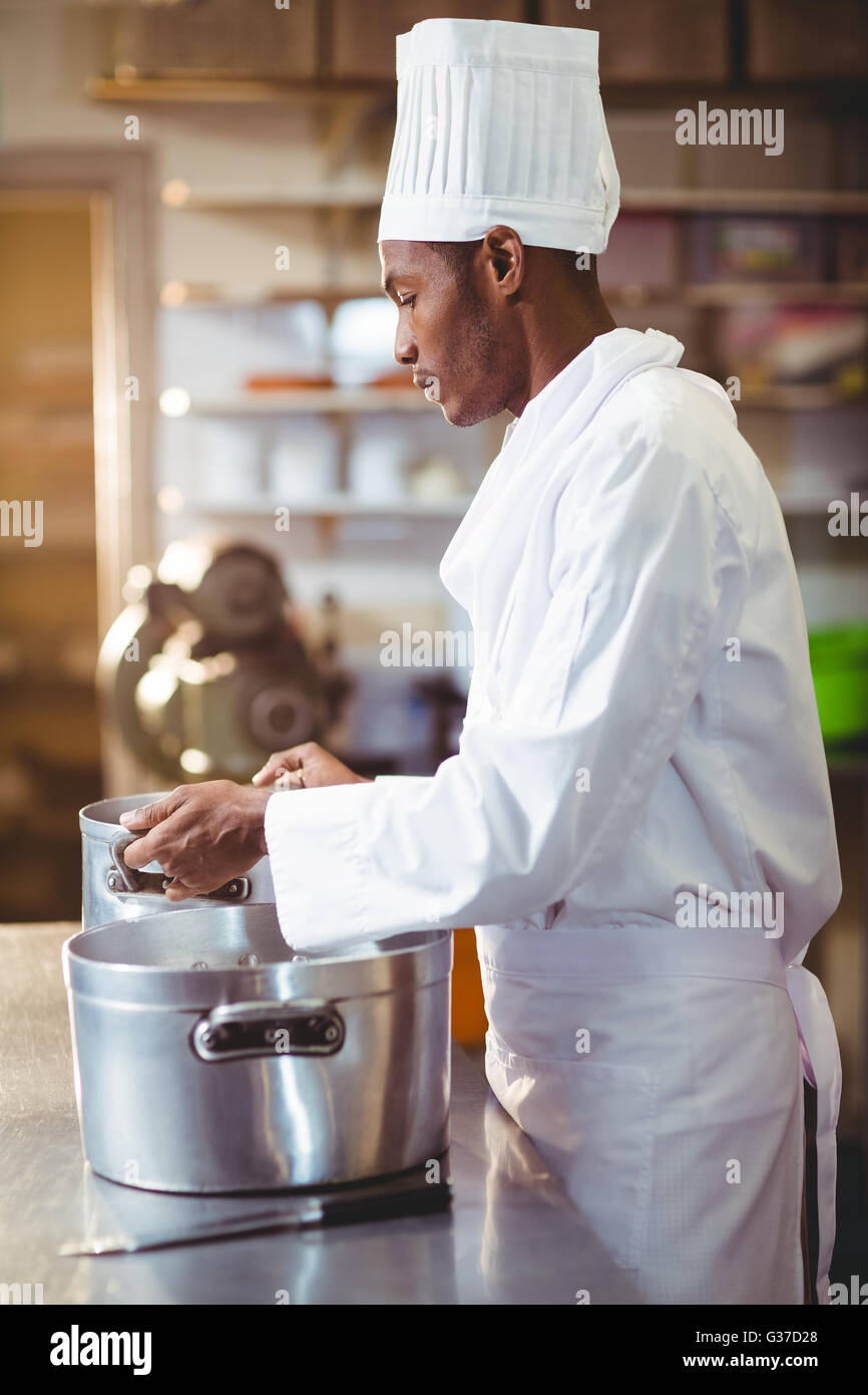 Chef holding cooking pot Stock Photo - Alamy