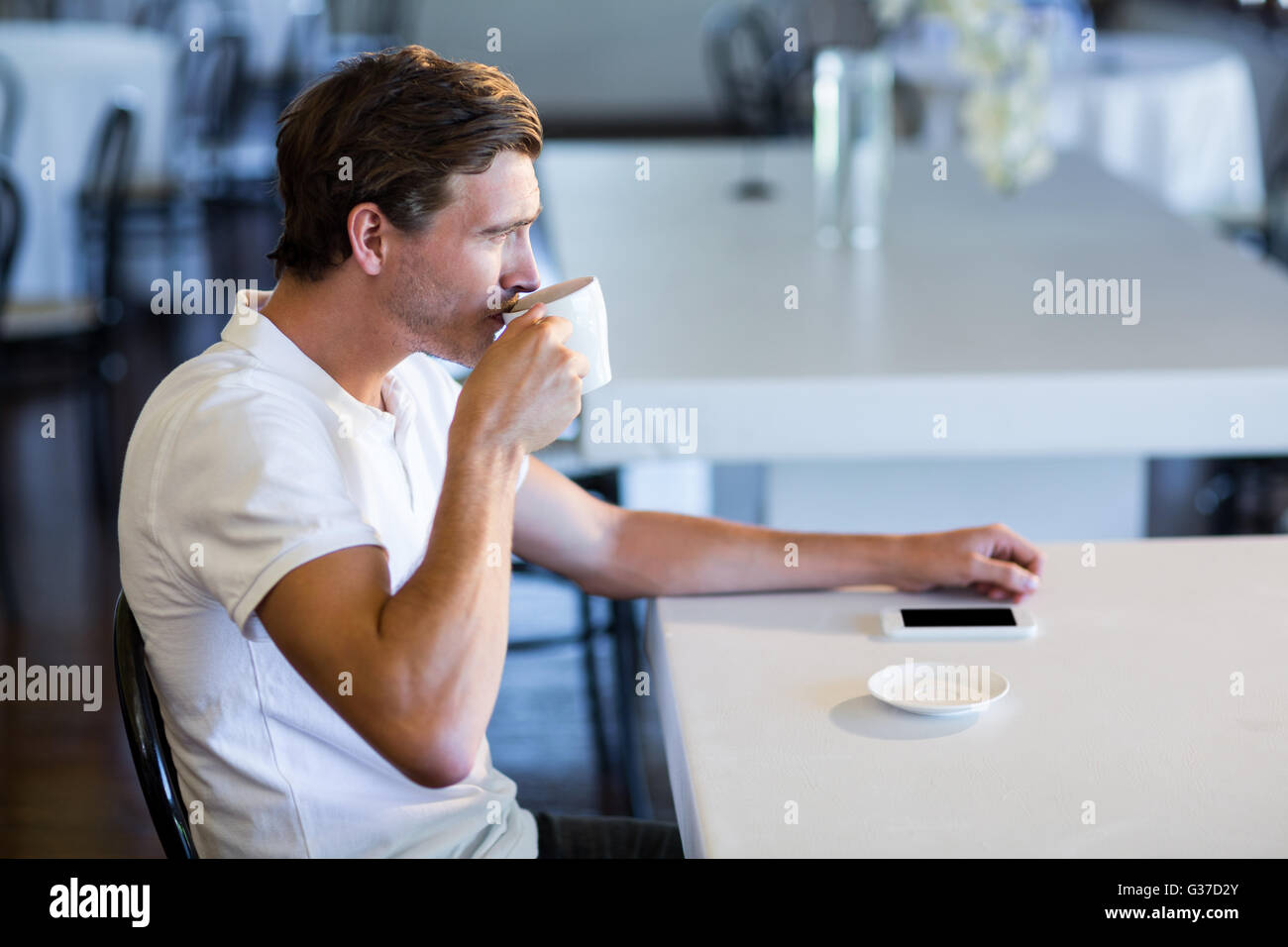 Man drinking cup of coffee Stock Photo - Alamy
