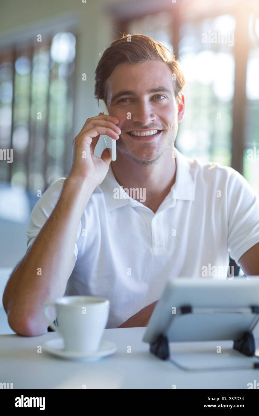 Smiling man talking mobile phone hi-res stock photography and images ...
