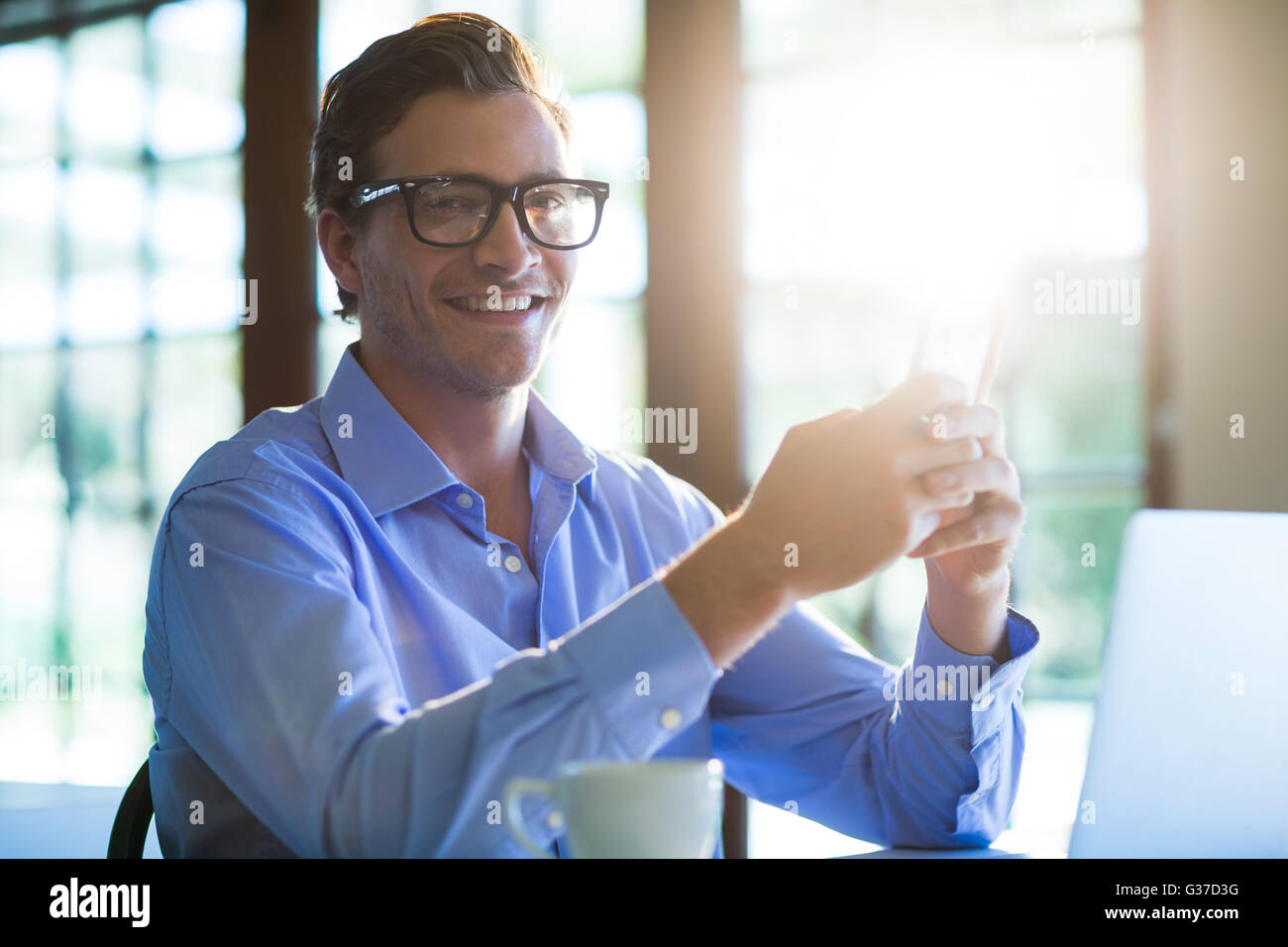 Portrait of man using mobile phone Stock Photo - Alamy