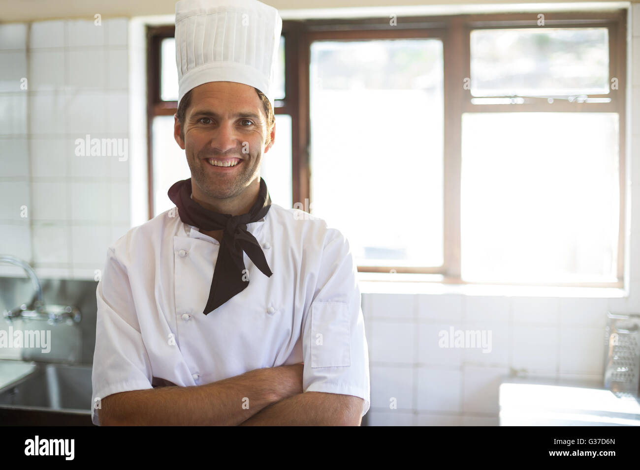 Portrait of smiling chef standing with arms crossed Stock Photo - Alamy