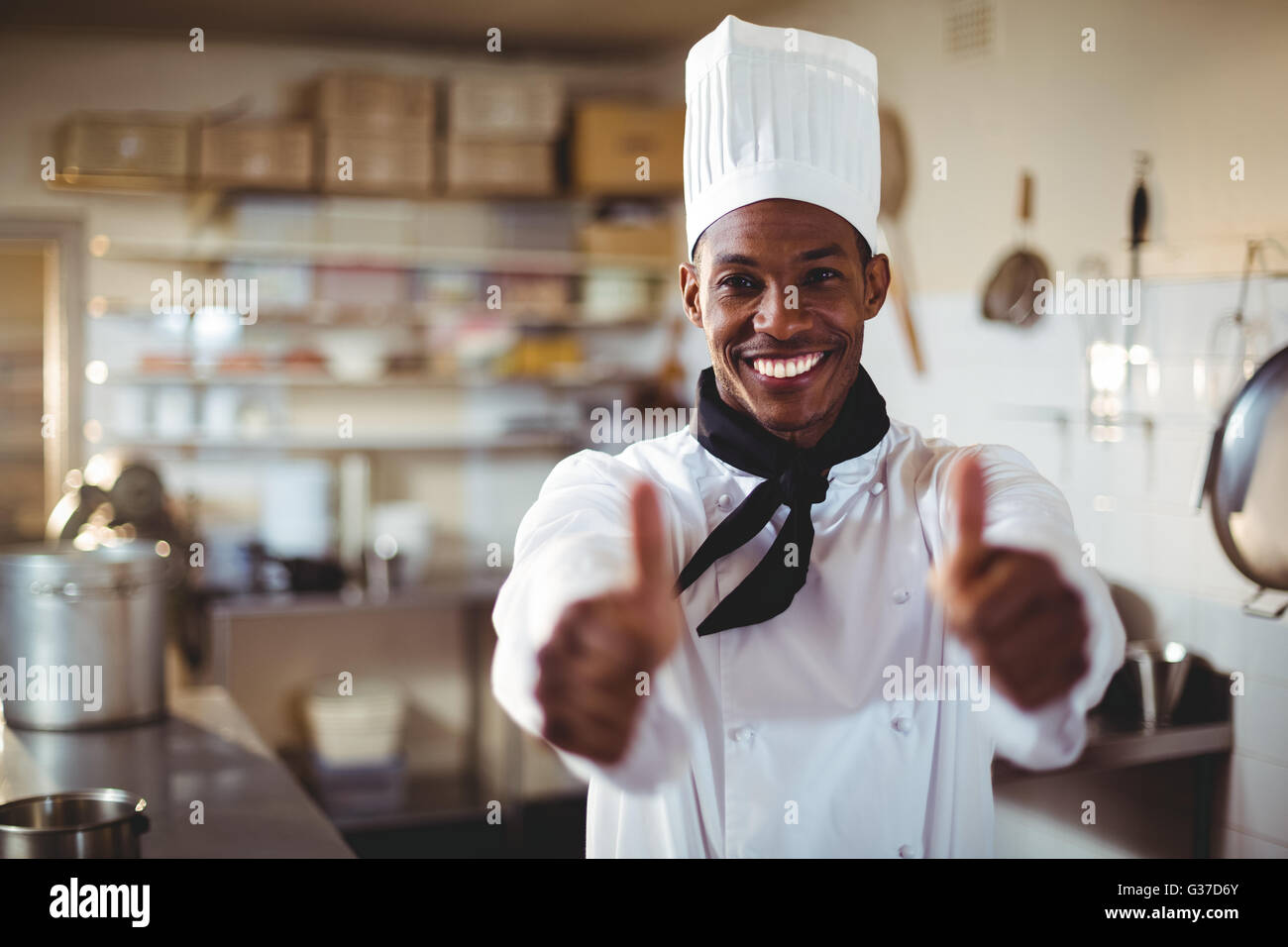Portrait of smiling chef showing thumbs up Stock Photo - Alamy
