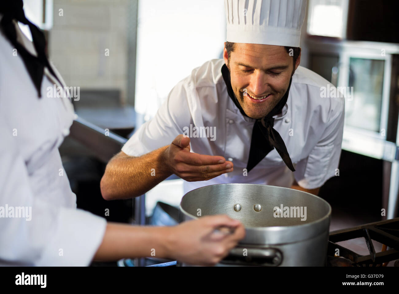 Head chef smelling the food Stock Photo - Alamy